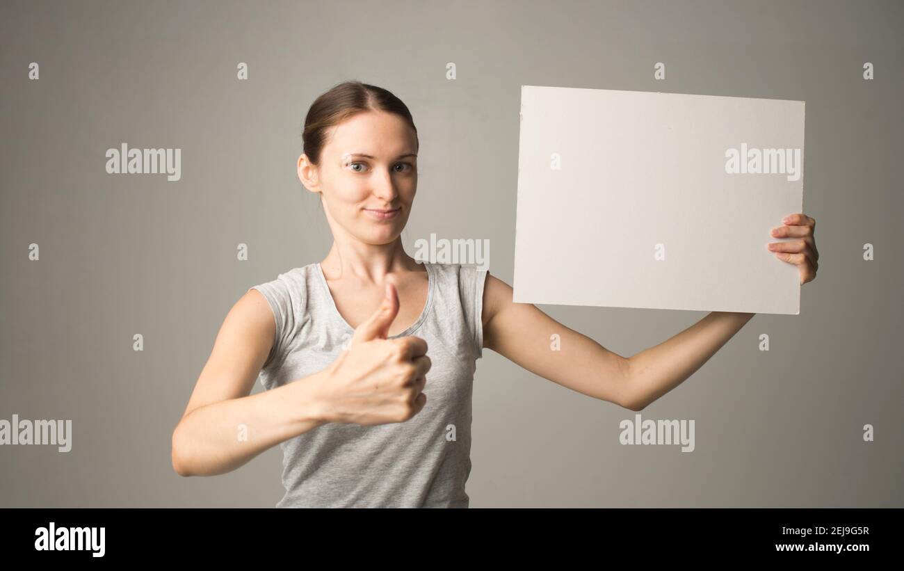 woman holding a sheet of paper in her hand Stock Photo - Alamy