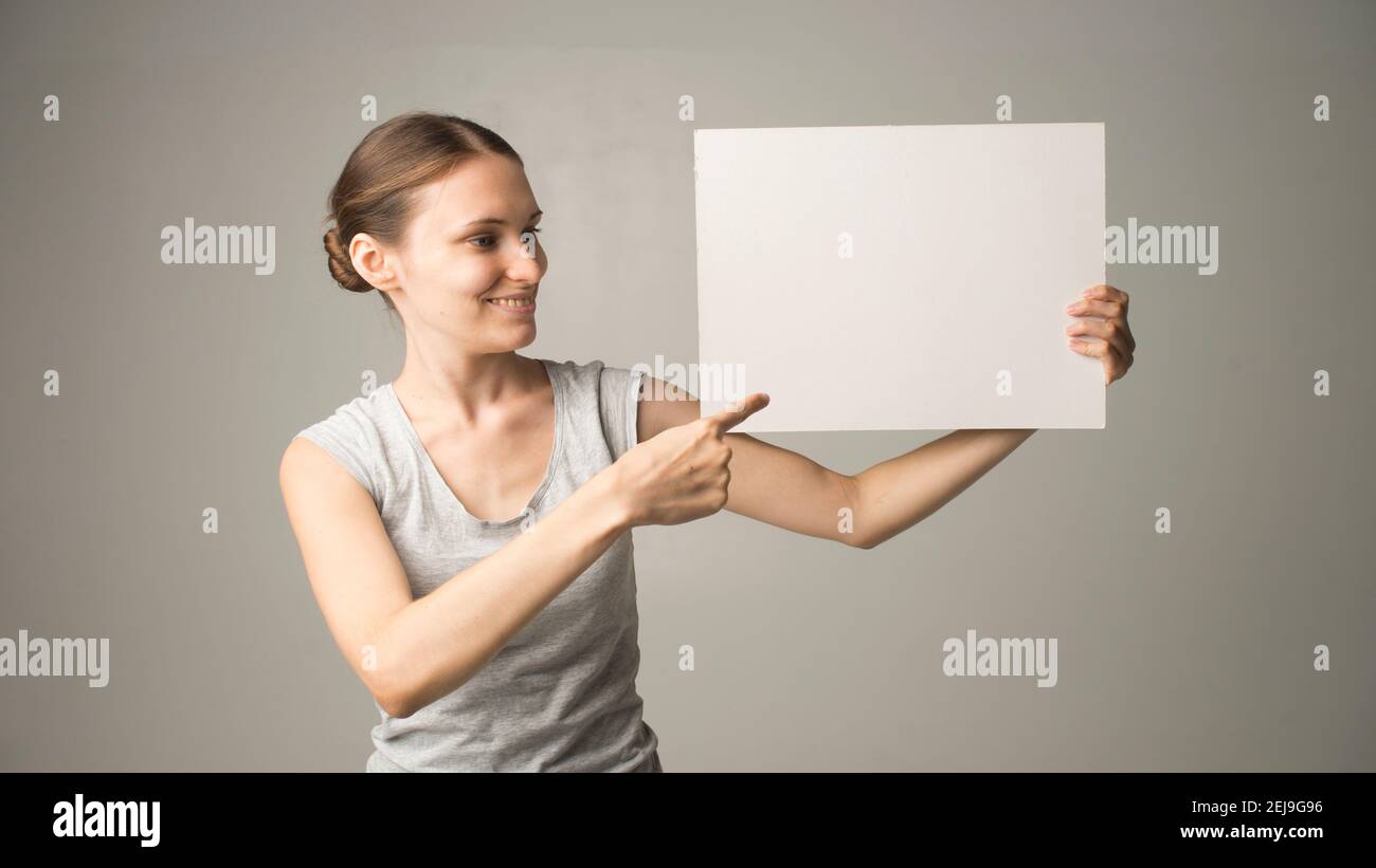 woman holding a sheet of paper in her hand Stock Photo - Alamy