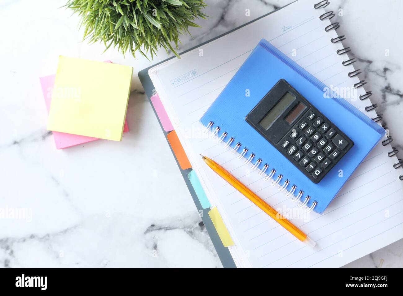 calculator and notepad on tiles background top down Stock Photo - Alamy