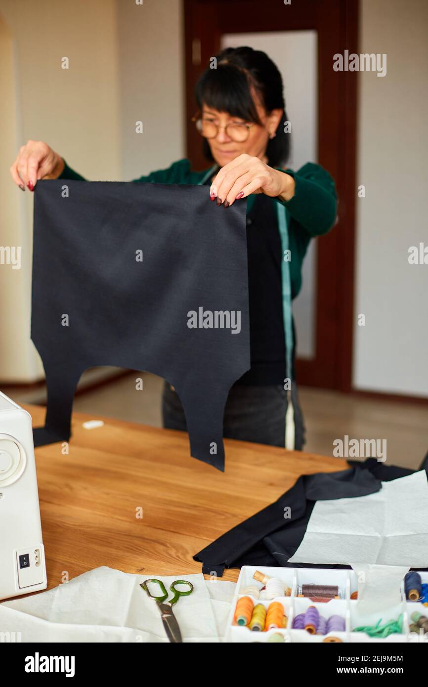 Step by step, woman dressmaker female measuring sewing pattern On Table ...