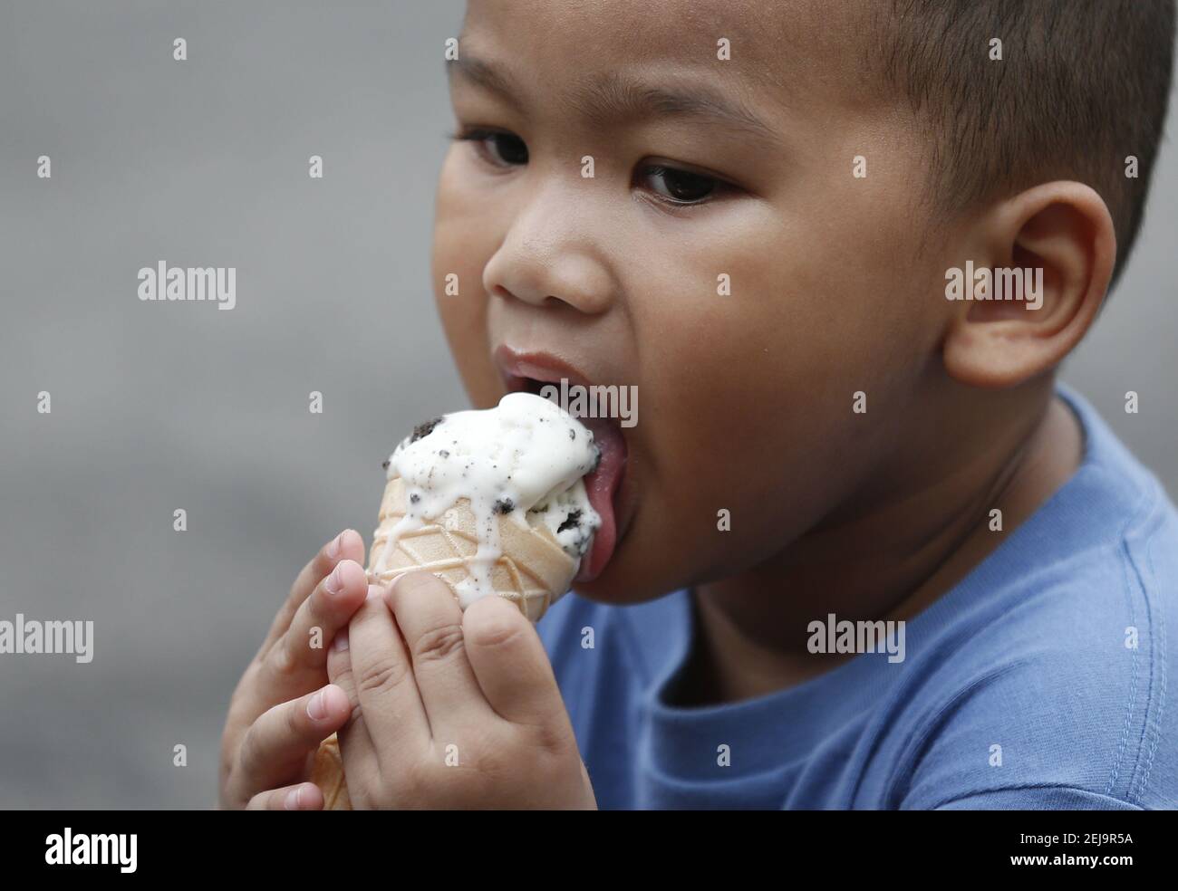 A boy eats ice-cream during the Children's Day celebration at ...