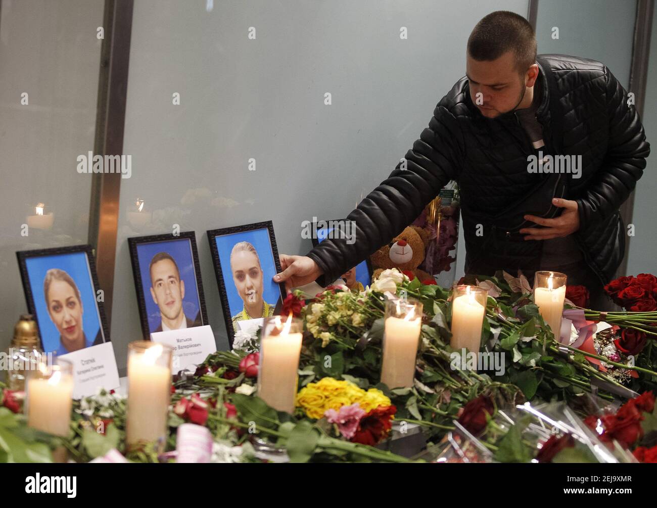 A man seen placing a portrait of a victim of flight PS 752 at the ...