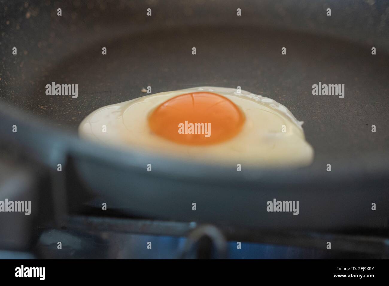 Egg frying in a pan Stock Photo - Alamy