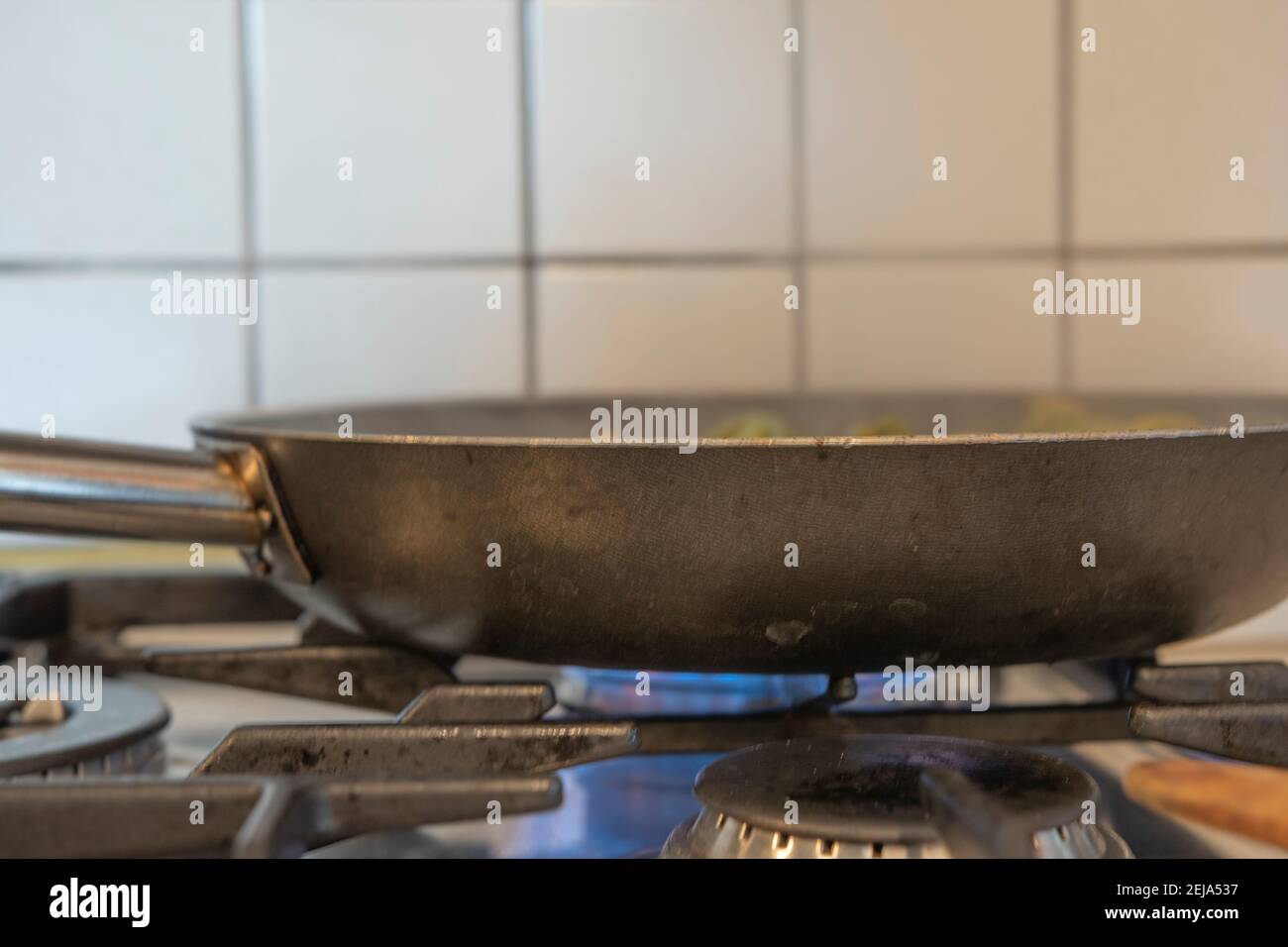 Pan cooking meal on a gas stovetop Stock Photo - Alamy