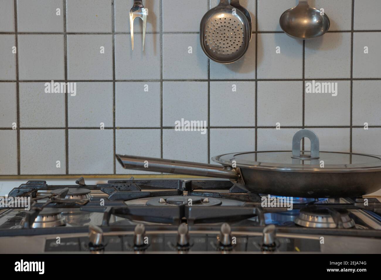 Pan cooking meal on a gas stovetop Stock Photo - Alamy