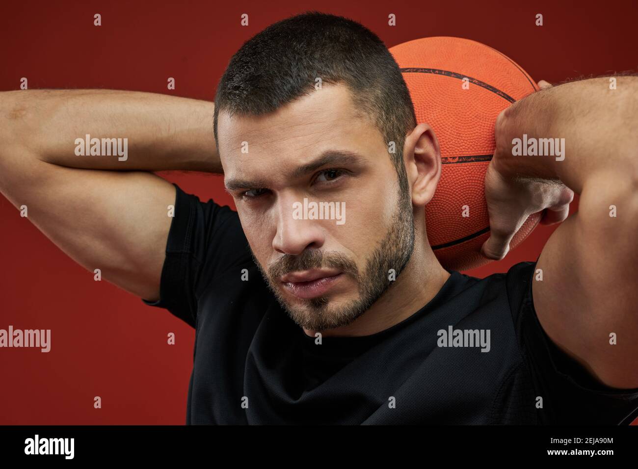Close up portrait of handsome bearded basketball player holding ...