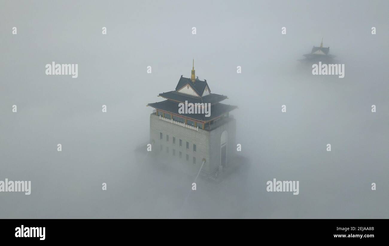 The landmark Wanfu Bridge is shrouded by dense fog in Yangzhou City ...