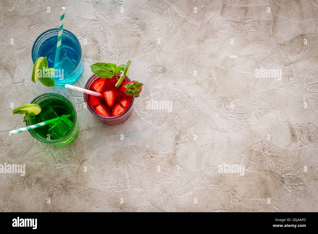 Cold green, blue and red cocktails with fresh fruits and mint Stock ...