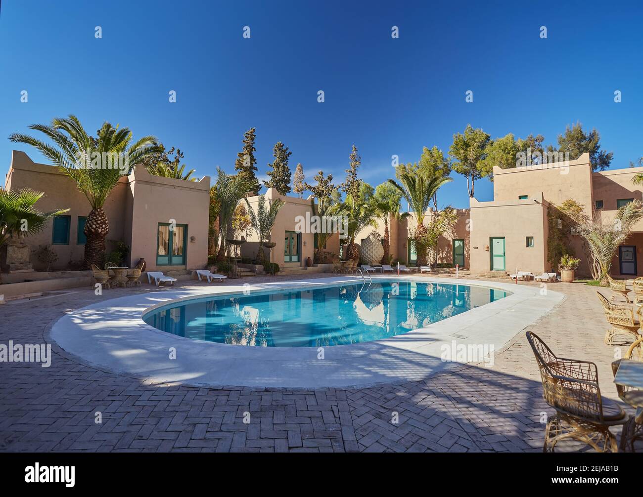 The inner courtyard with a swimming pool in Moroccan hotel Stock Photo ...