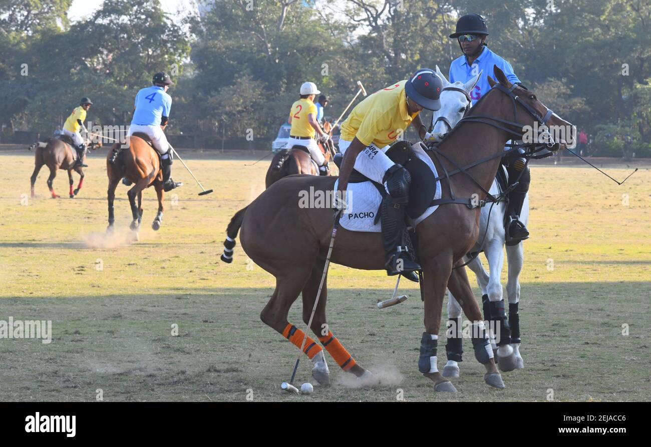 Players of VG (in blue) and Umang (in yellow) in action during the ...