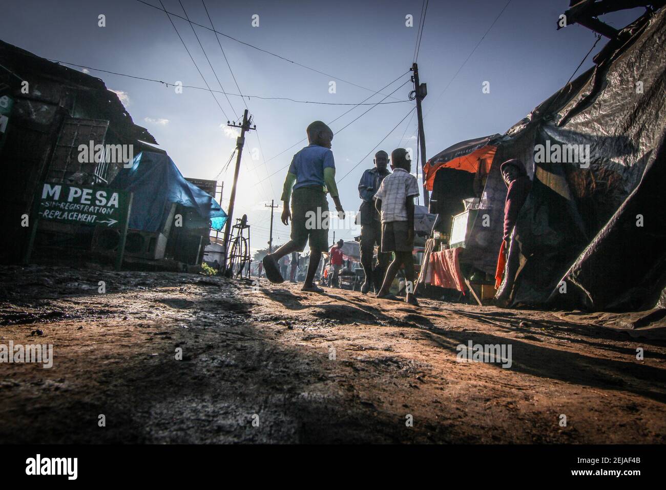 Residents of Kibera Slums find their way past the streets wired with ...
