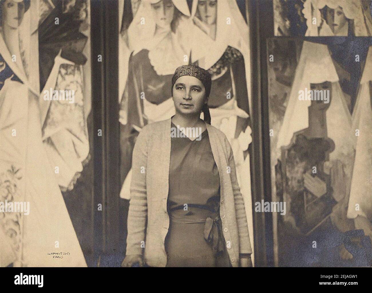 Natalia Sergeevna Goncharova (1881-1962) at her studio with the paintings "Spanish Women" and ...