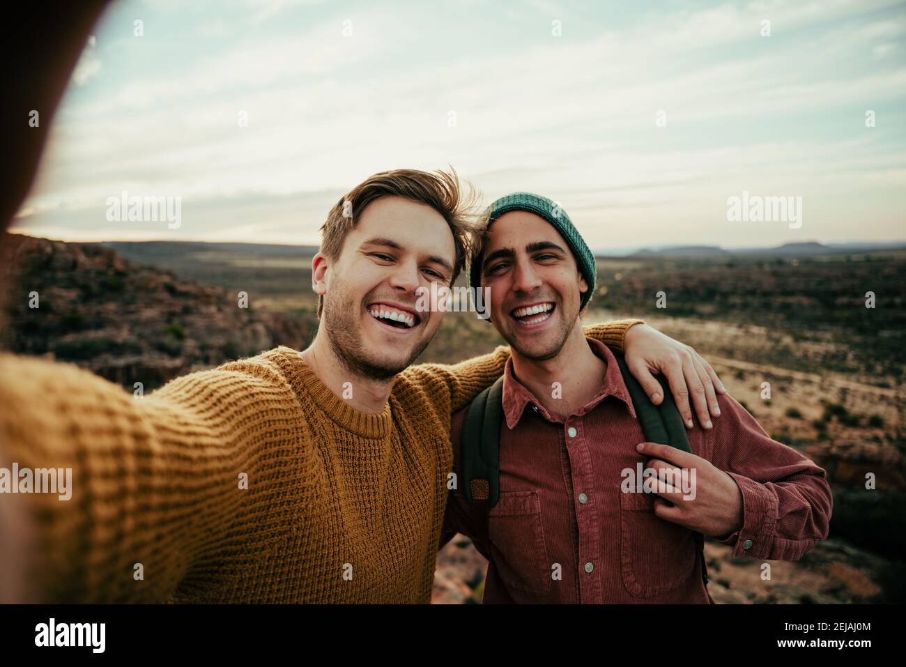 Caucasian male friends hiking in wilderness taking selfie with cellular ...