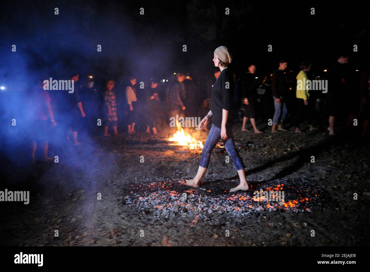 Group of people walking on embers performing pagan ritual. November 11 ...