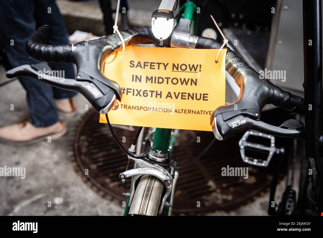 A sign demanding bike rider safety is attached to the bike of a ...