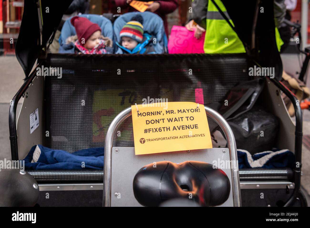 A sign demanding bike rider safety is attached to a vehicle of ...