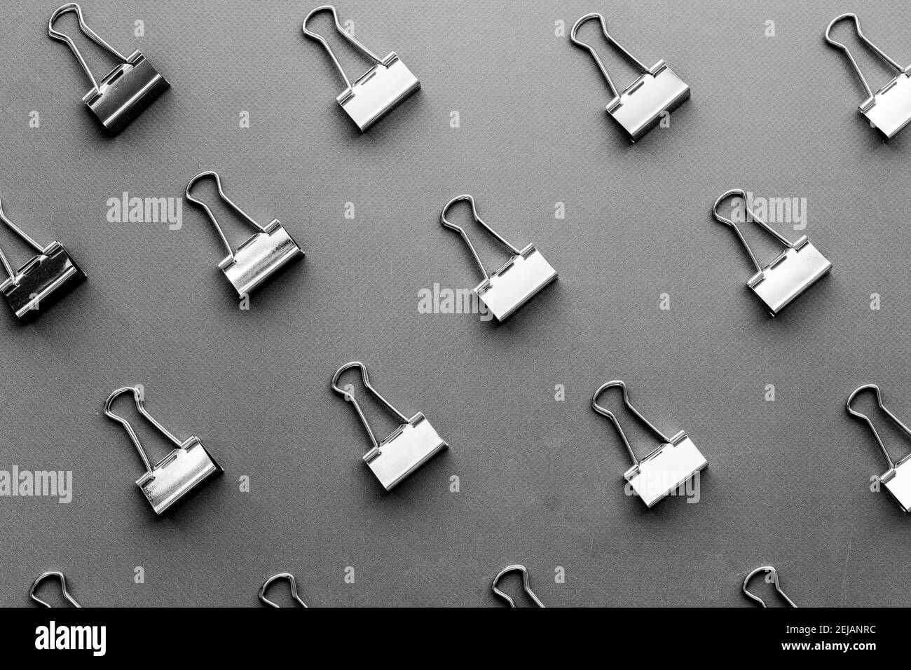 Stationery pattern. Paper binder clips top view Stock Photo - Alamy
