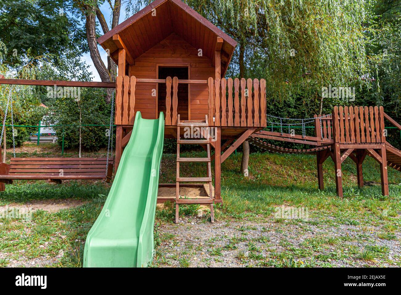 Empty modern wooden children playground set on green yard in public ...