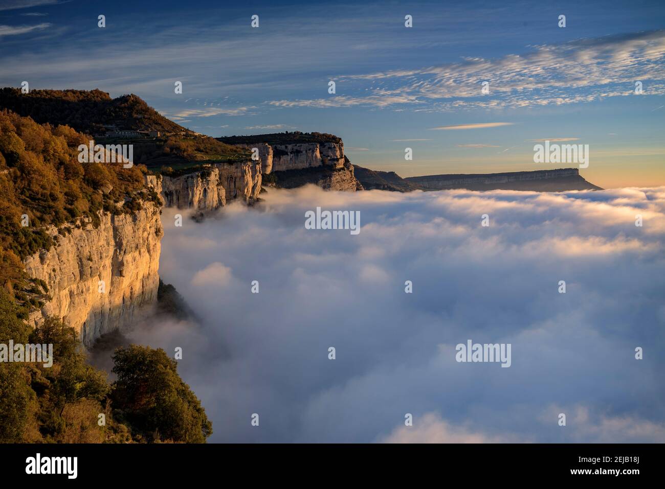 Sunrise over a sea of clouds seen from the Avenc de Tavertet Cliffs ...