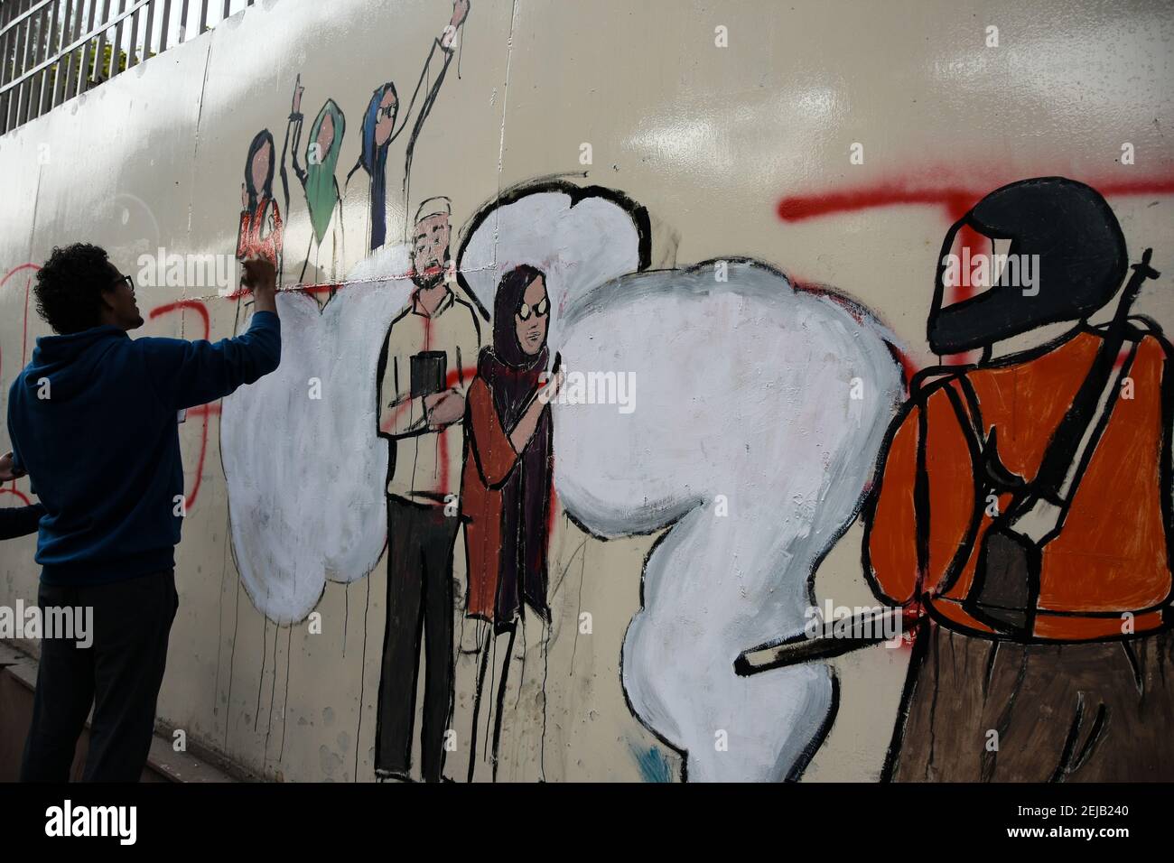 A Fine art student paints graffiti out side the jamia millia islamia ...
