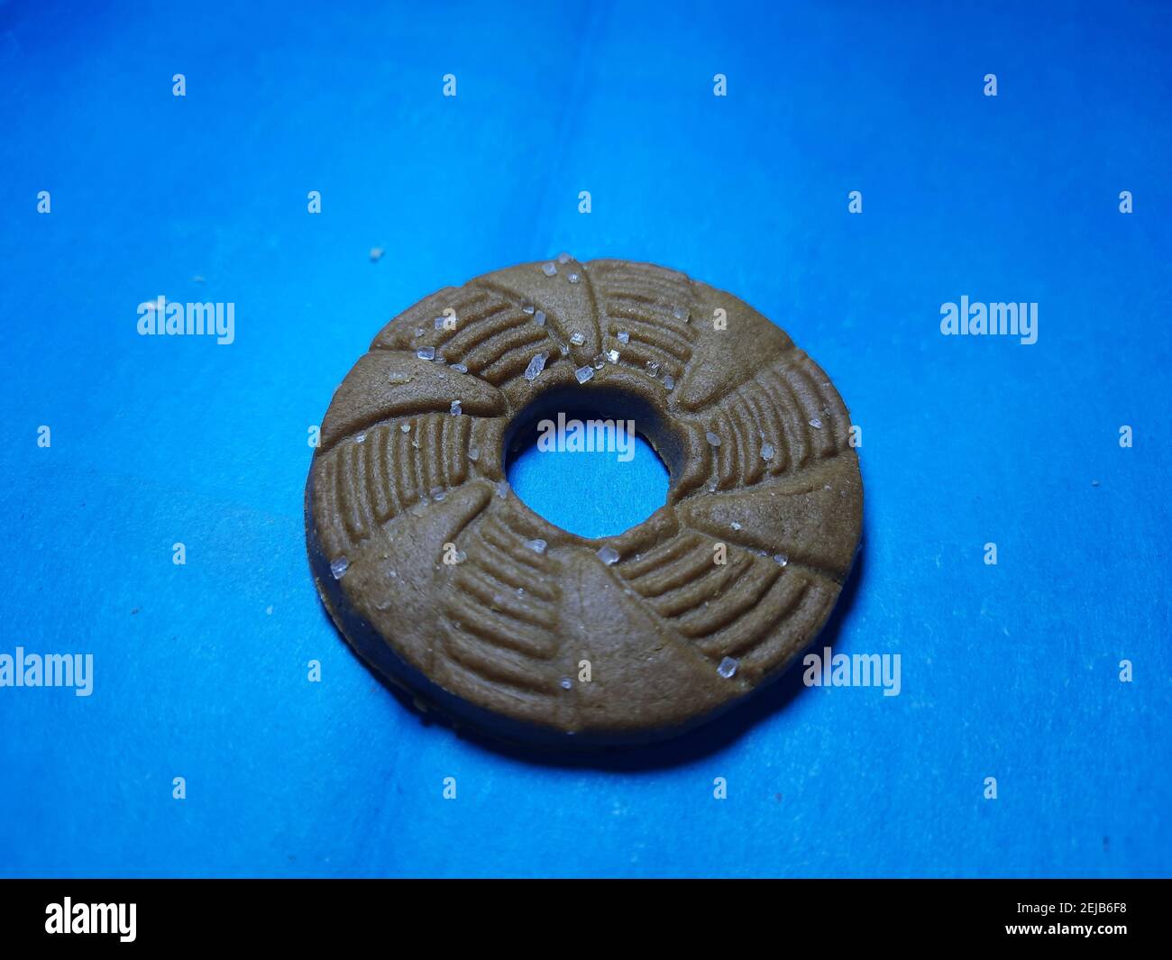 Closeup shot of a biscuit on blue background Stock Photo - Alamy