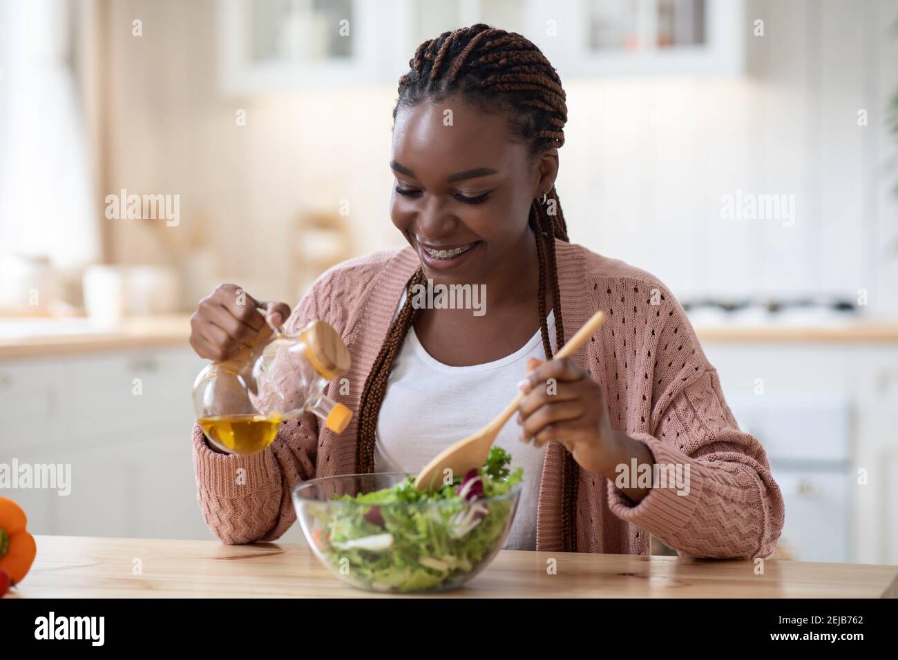 Black woman cooking in kitchen hi-res stock photography and images - Alamy