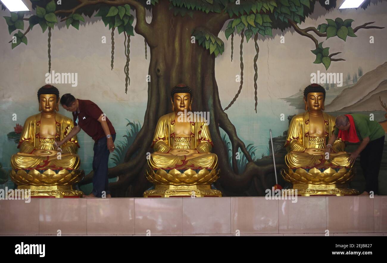 Men clean statues during the celebration at the Amurva Bhumi temple in ...