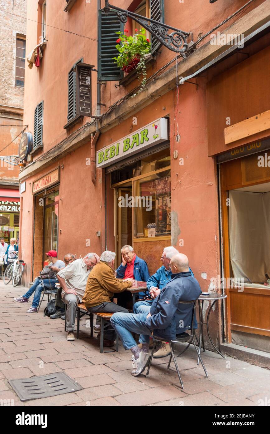 A group of men sitting at tables outside the Bebi Bar in Bologna Italy ...