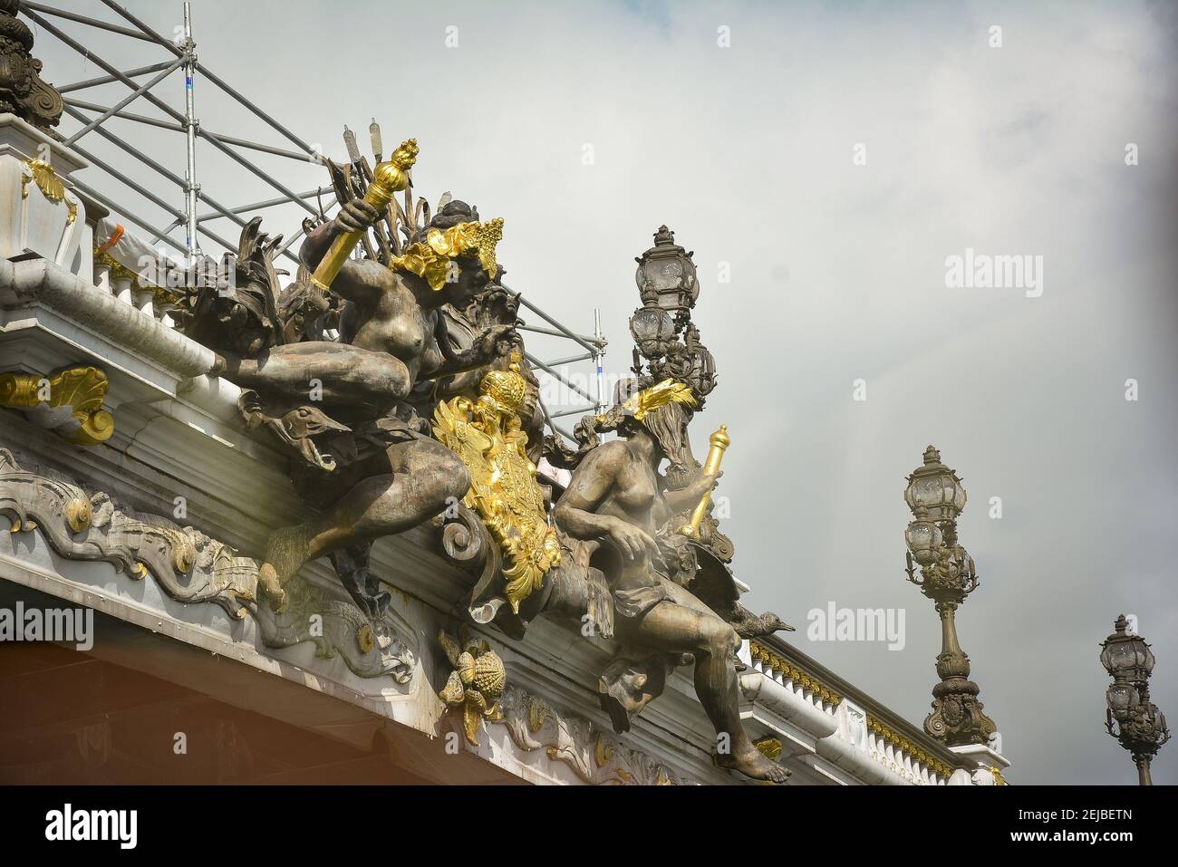 Low angle shot of statues and street lamps on the bridge in Paris Stock ...