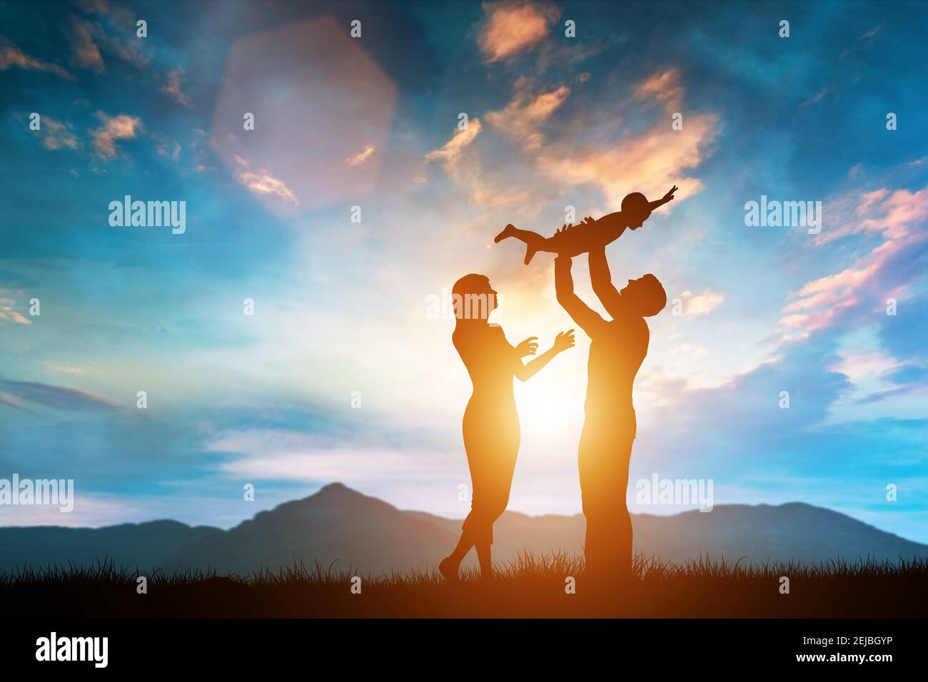 Happy family together outside at sunset, father lifting the baby up ...