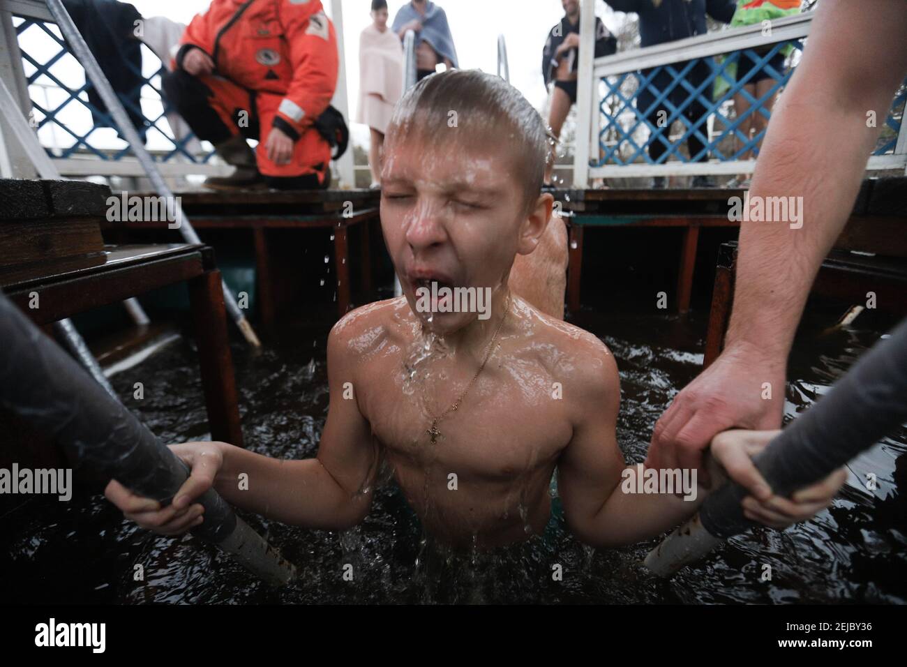Orthodox Christians dive into iced water during the Epiphany ...