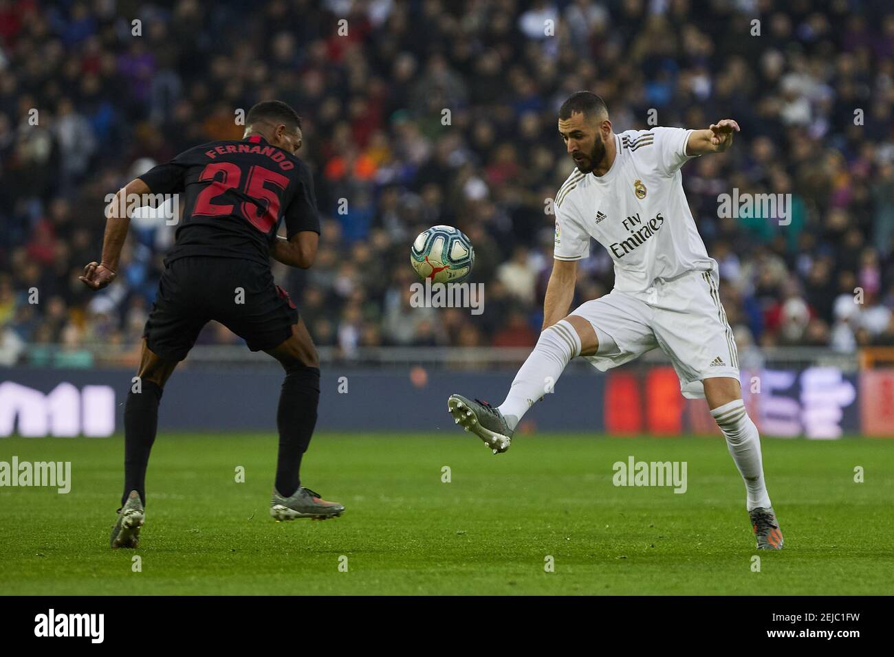 Karim Benzema of Real Madrid and Fernando Reges of Sevilla FC during La ...