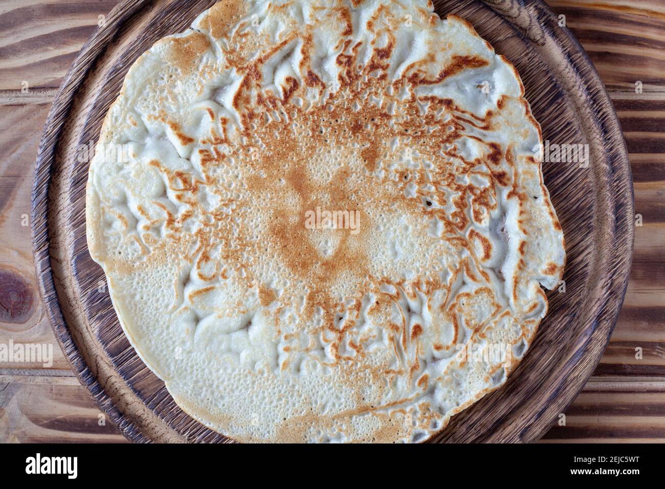 Fried pancake on old wooden table. Top view Stock Photo - Alamy