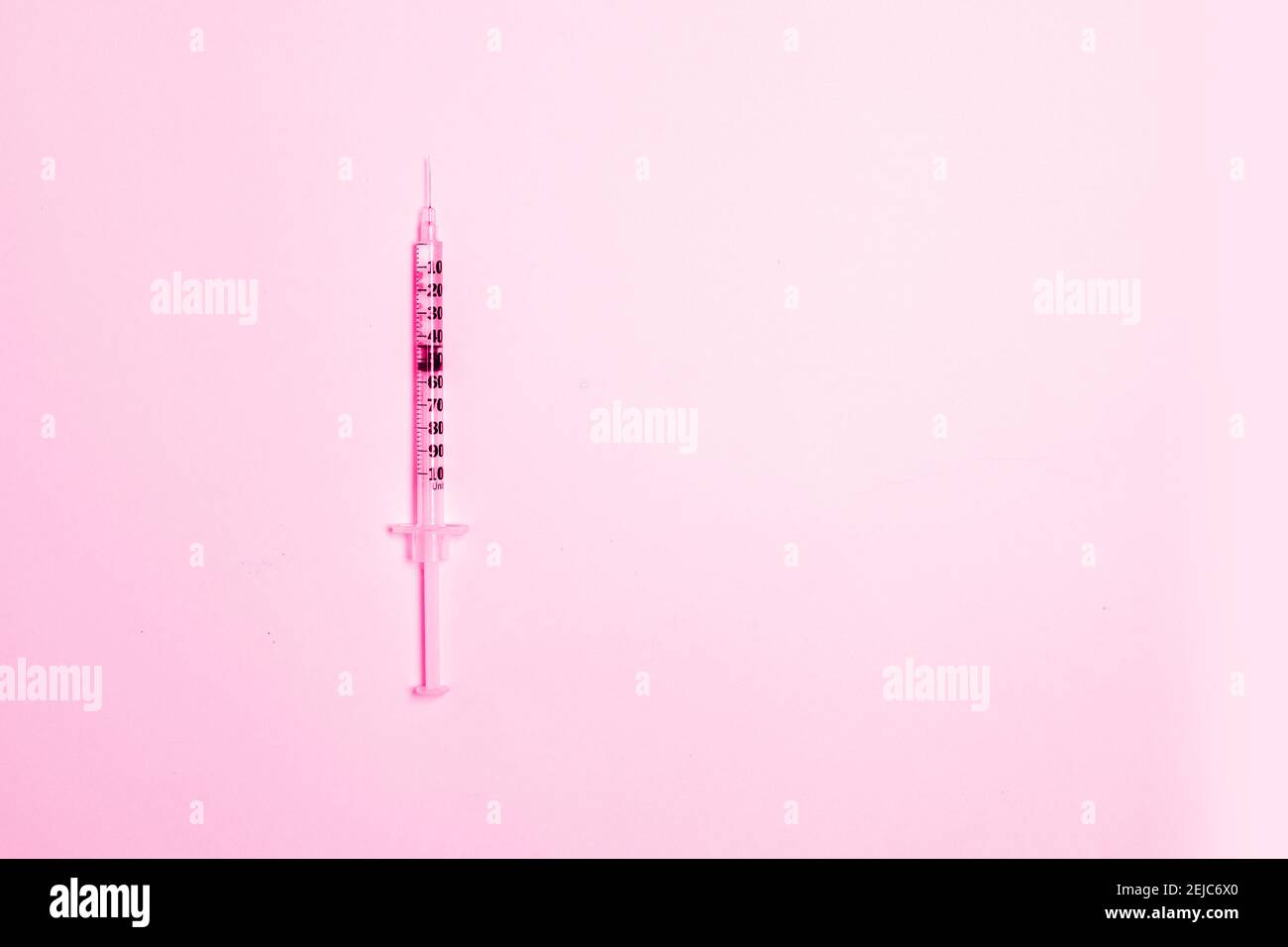 Cosmetic injections to restore skin youth. Slim syringe on pink ...