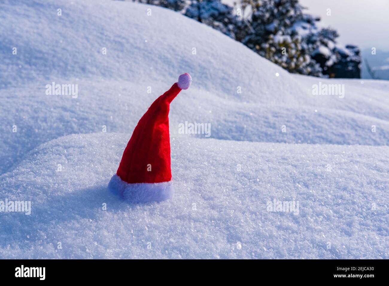 A small red christmas cap placed on snow Stock Photo - Alamy