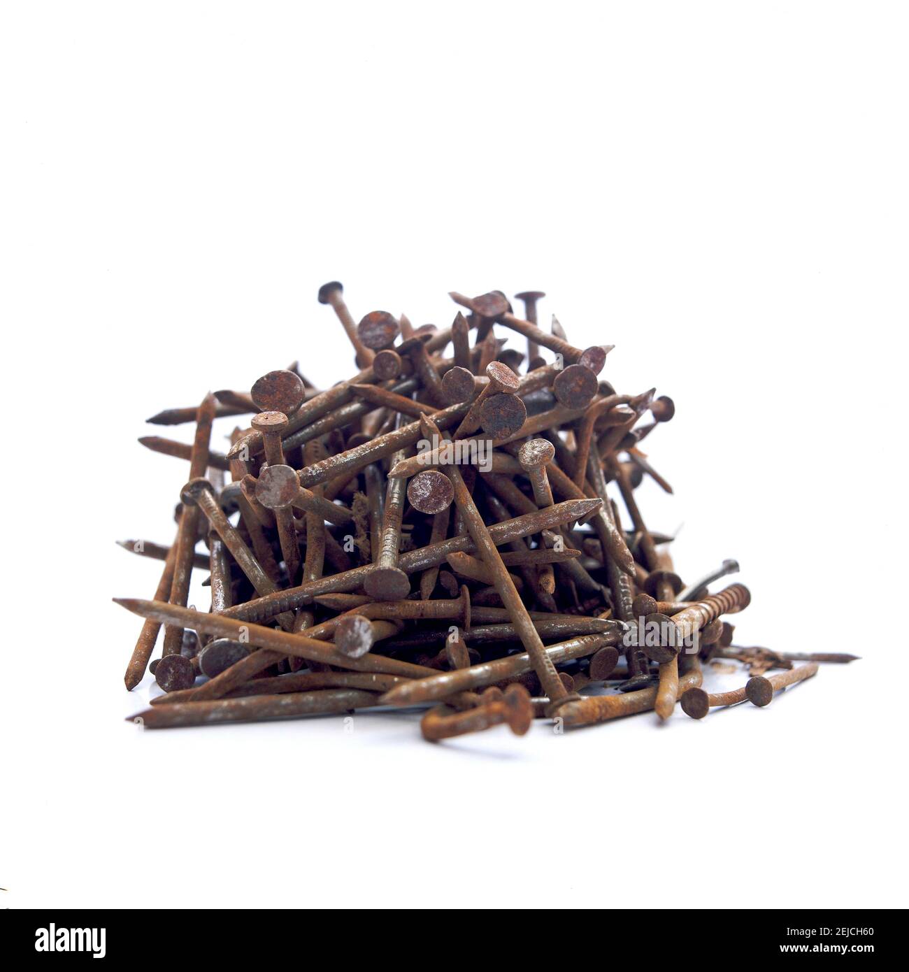 Pile of rusty steel nails on white background Stock Photo - Alamy