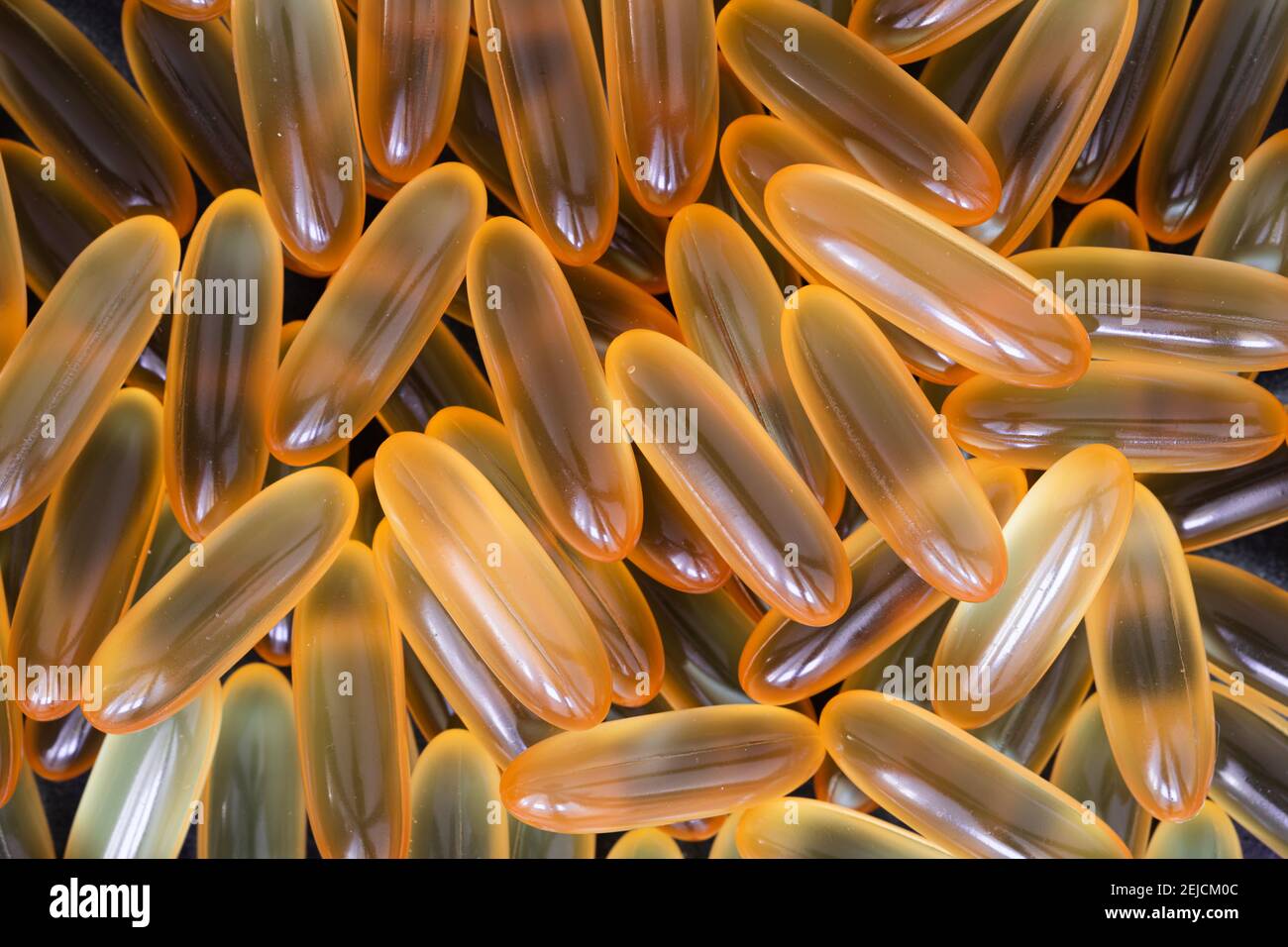 pile of omega 3 and vitamin d capsules background Stock Photo - Alamy