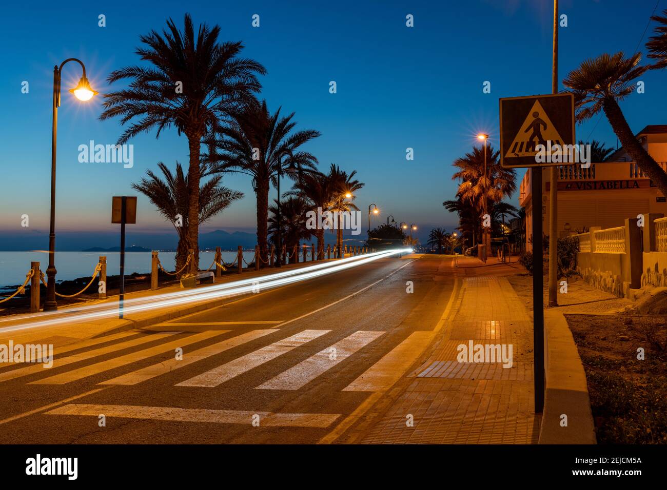 A long exposure night view of ocean front street with light lines from ...
