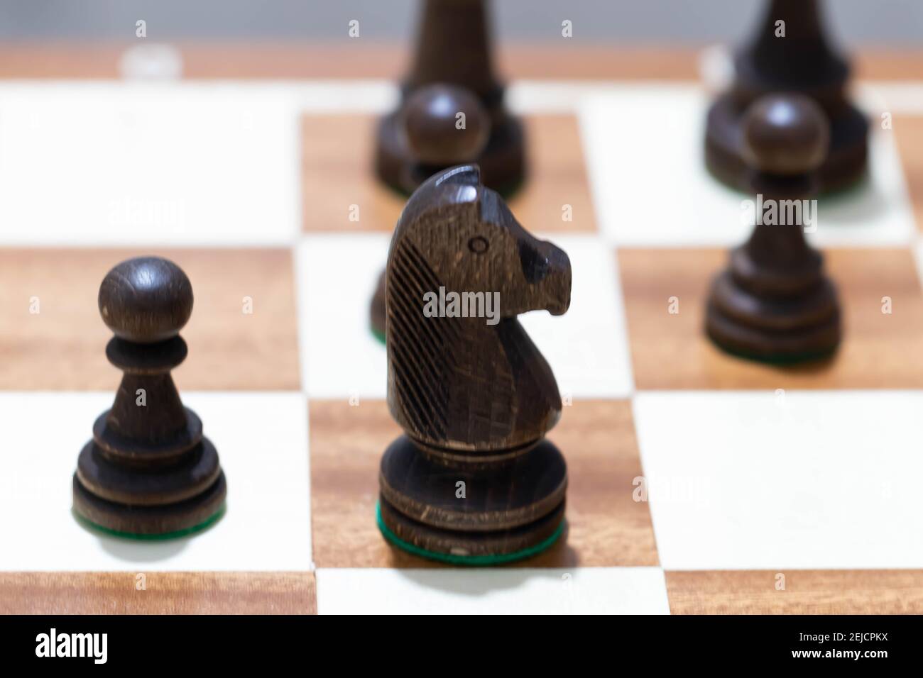 Playing wooden chess on a chessboard. Tactics and strategy. Black and white shapes Stock Photo ...