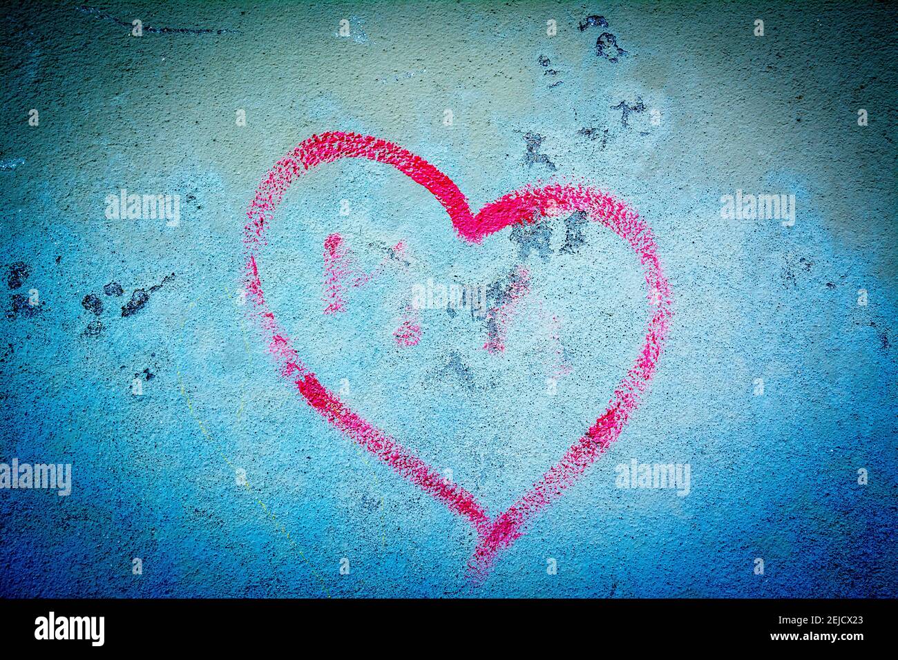 Heart drawing on a concrete surface in a vibrant pink color, showcasing ...