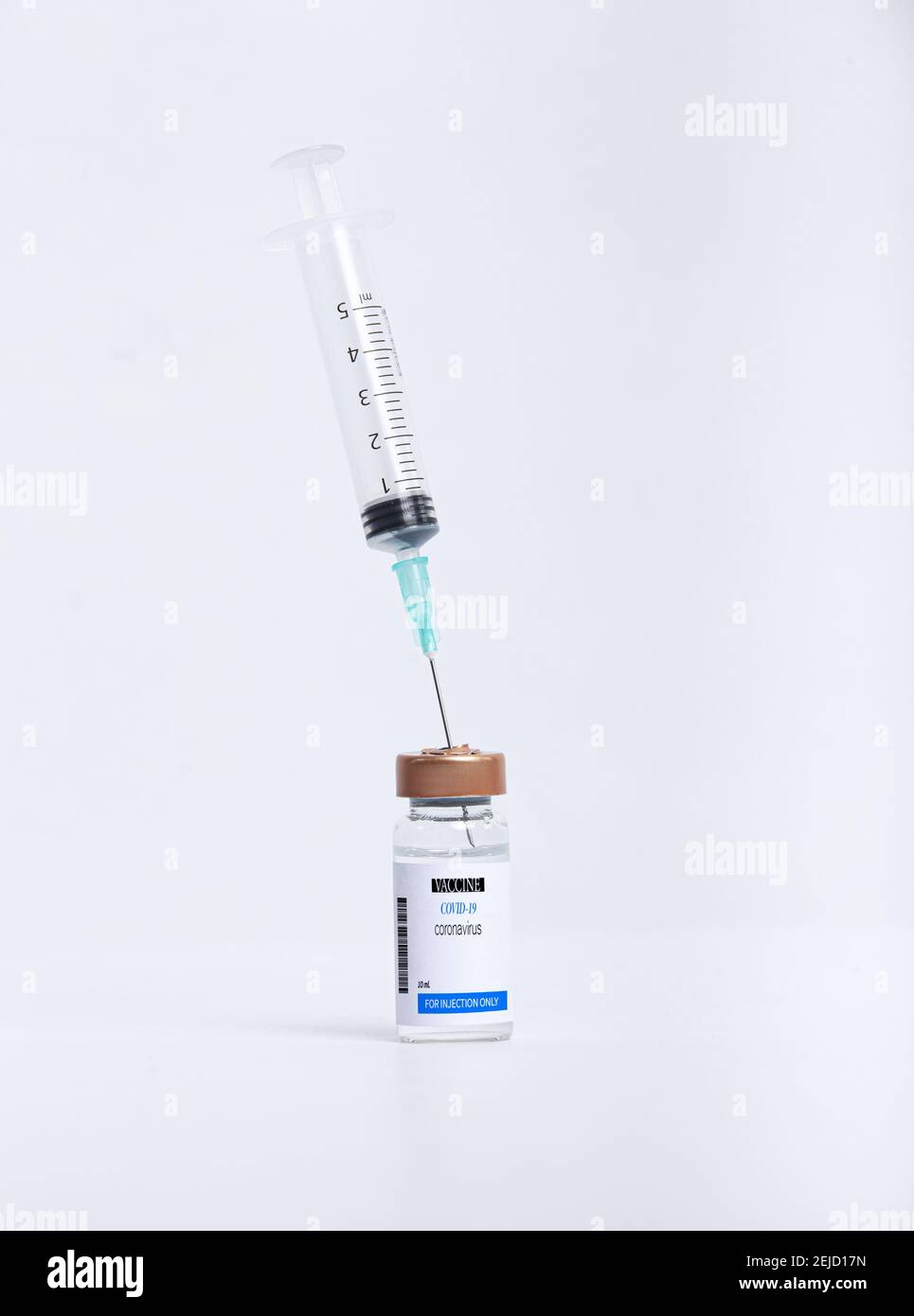 Vertical shot of a Covid -19 vaccine vial and syringe for injection ...