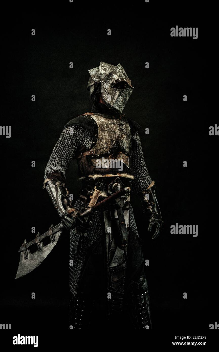 Medieval fighter in armor, in profile, an ax in his hand Stock Photo ...
