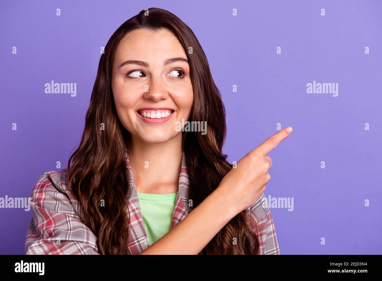 Photo of young dreamy cheerful woman point finger empty space promo ...