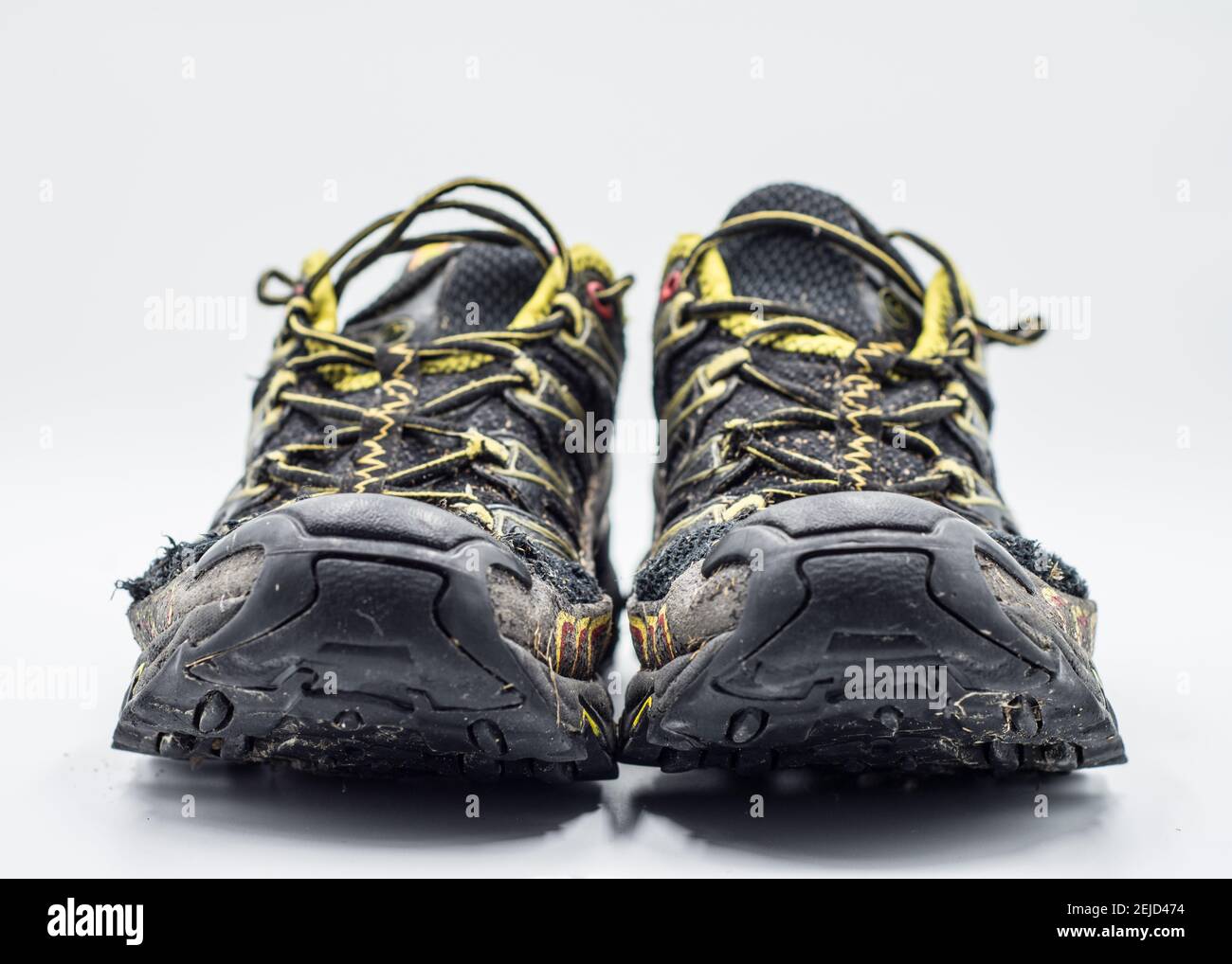 Dirty trail running shoes over white background Stock Photo - Alamy