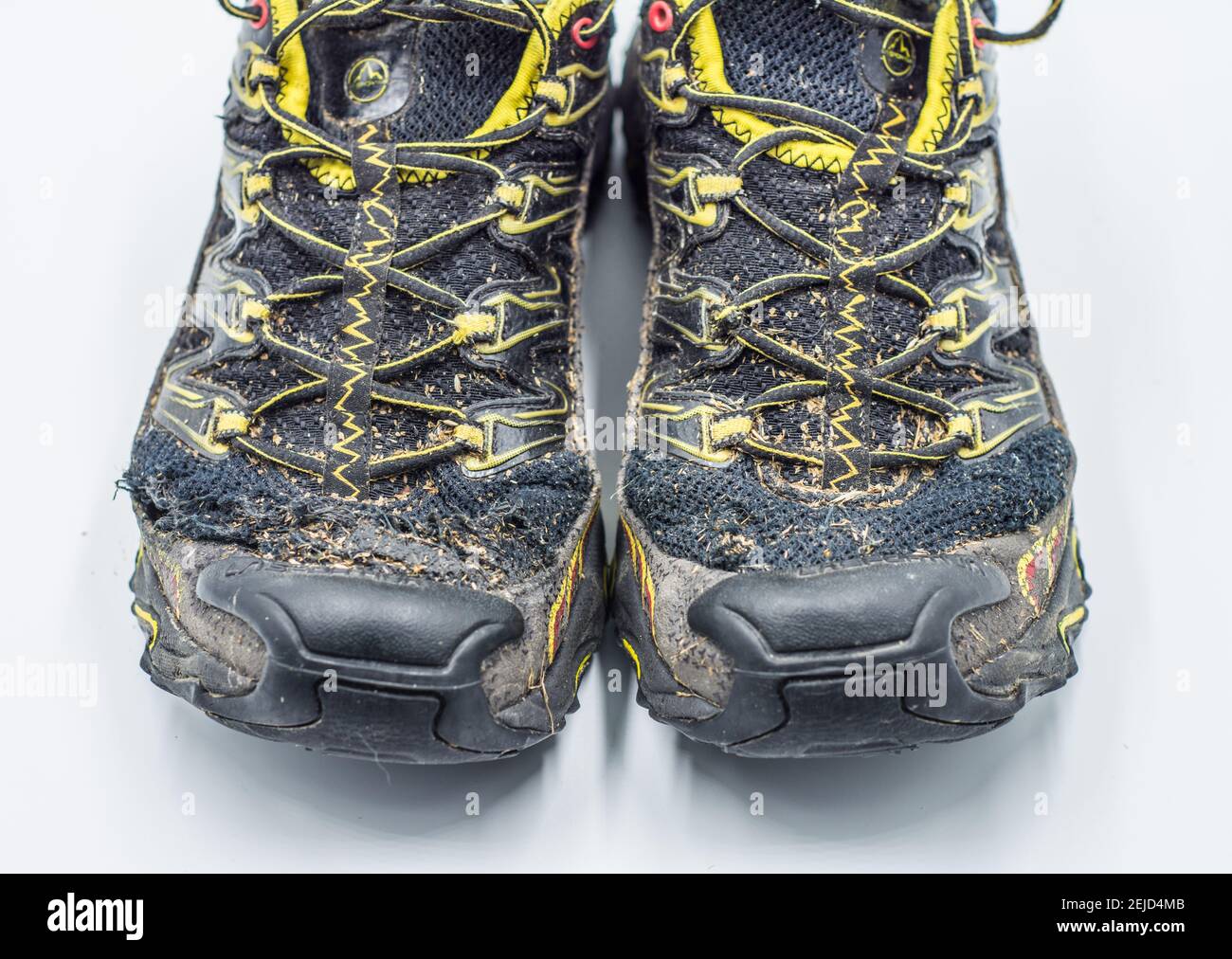 Dirty trail running shoes over white background Stock Photo - Alamy