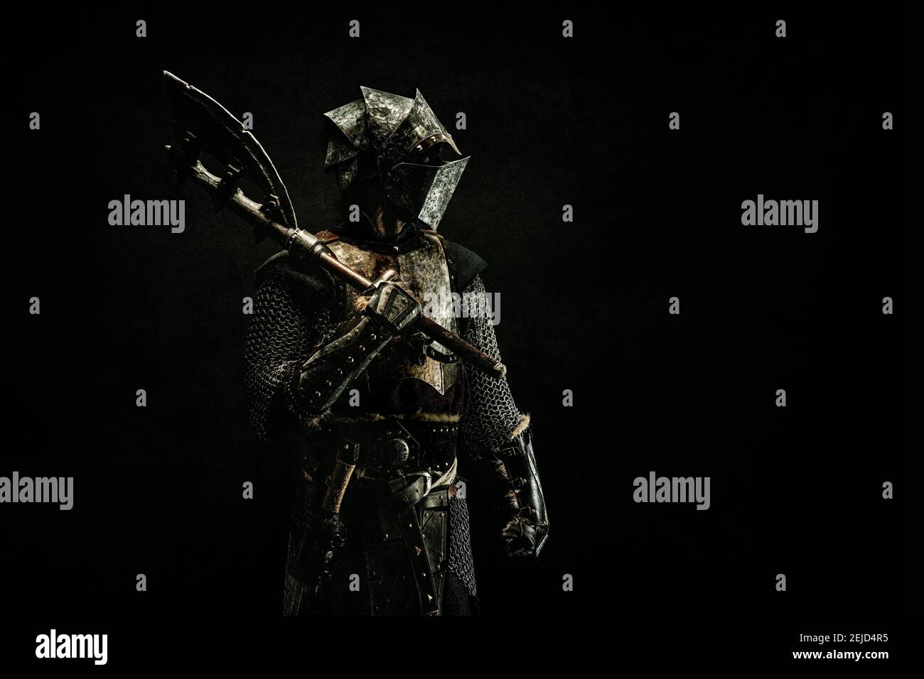 Portrait of a medieval fighter in armor, in profile, an ax on his ...