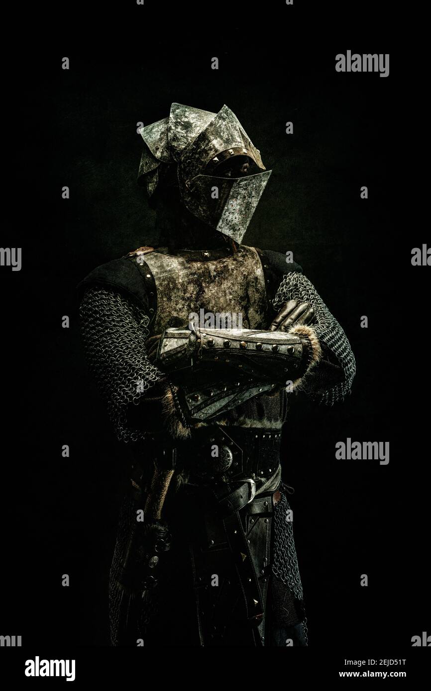 Portrait of a medieval fighter in armor with his arms crossed Stock ...
