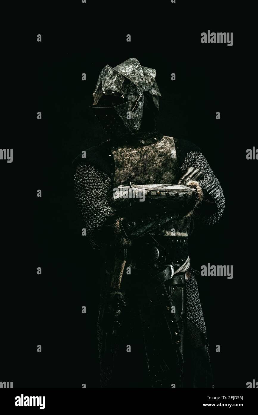 Portrait of a medieval fighter in armor with his arms crossed Stock ...