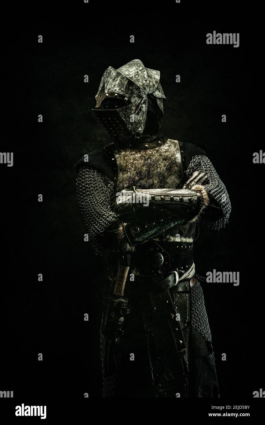 Portrait of a medieval fighter in armor with his arms crossed Stock ...