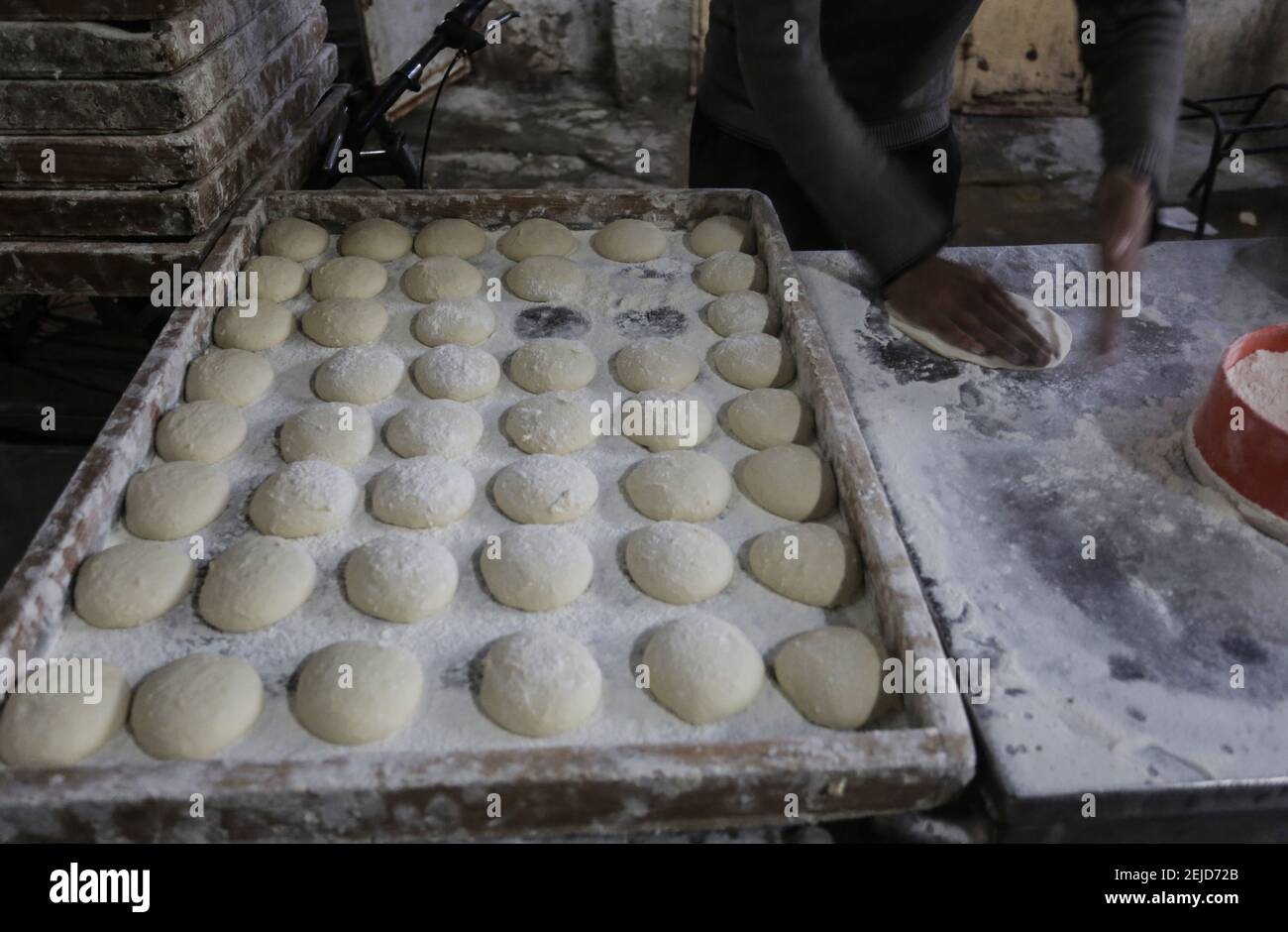 A Palestinian seller prepares traditional bread known as "Saj" in Gaza ...